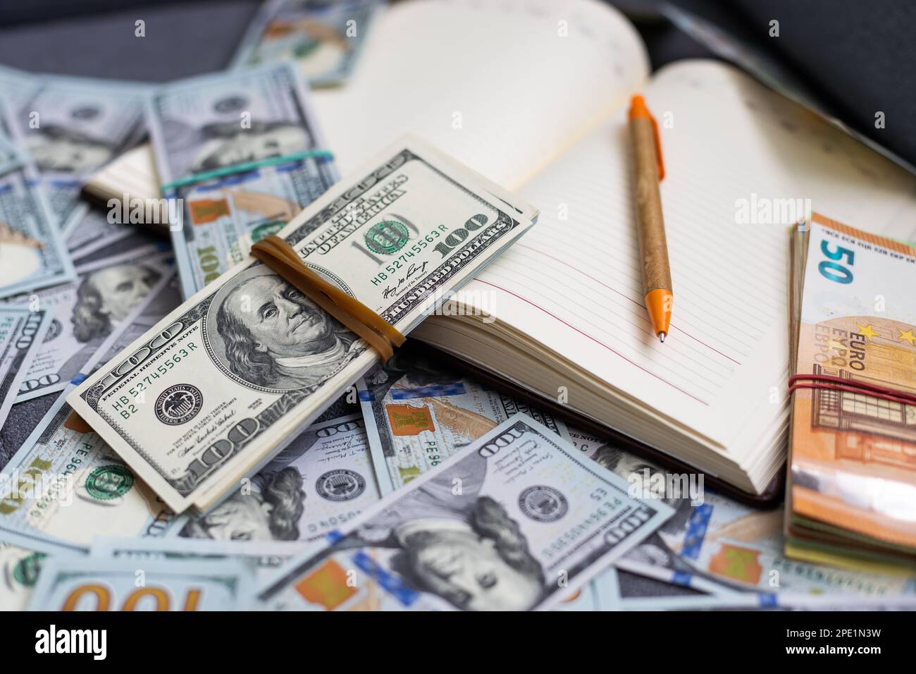 Notebook with vintage fountain pen and euro banknotes between the pages ...