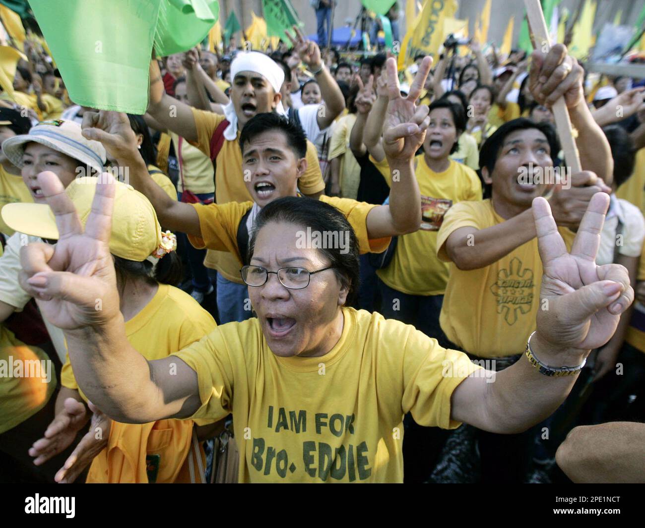 Filipino protesters flash a peace sign as they call for the resignation ...