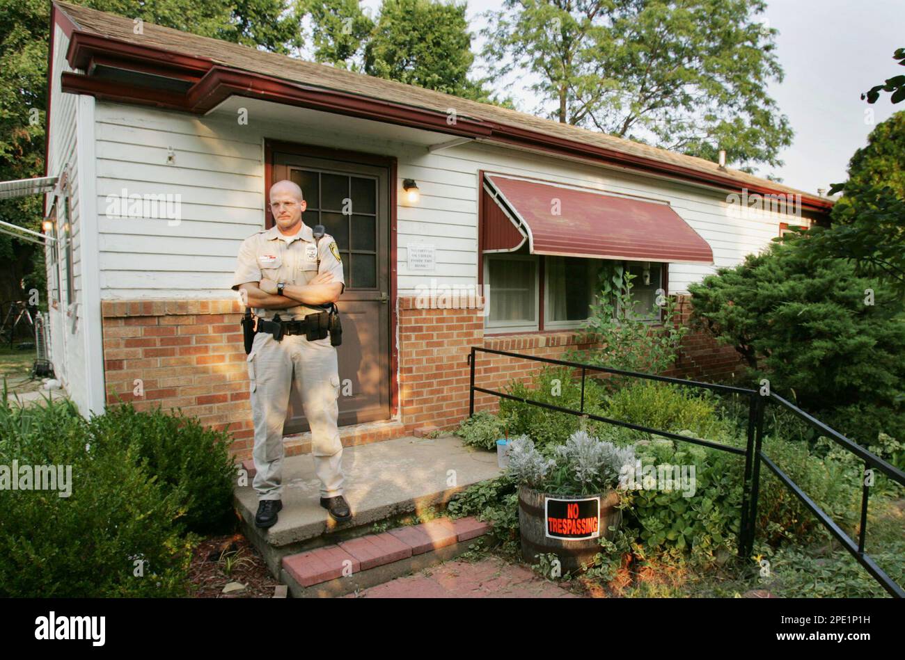 A Park City Ks Police Officer Guards The Front Door Of Dennis Rader