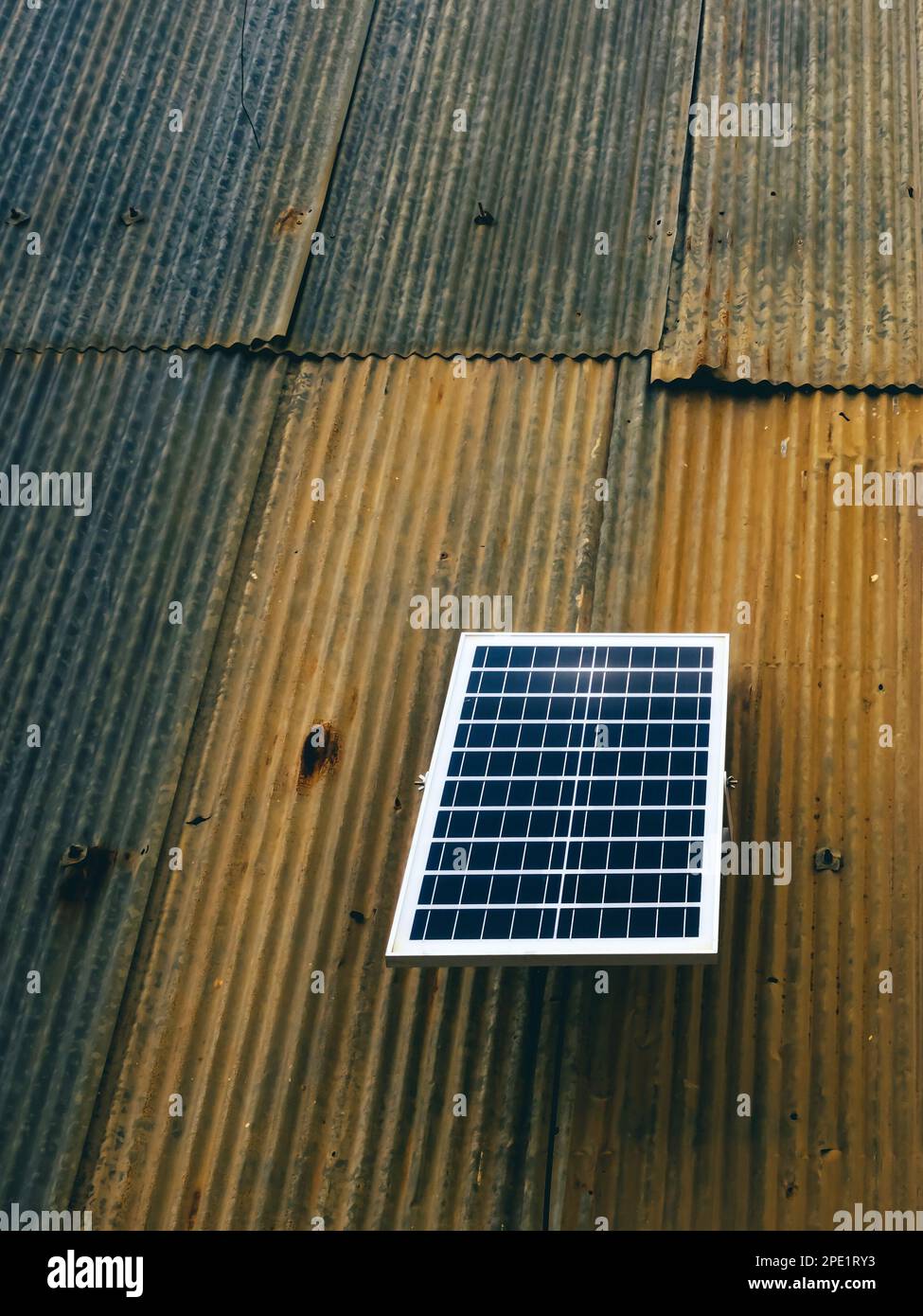 Solar panel attached on old zinc wall. Electric solar panel on the ...