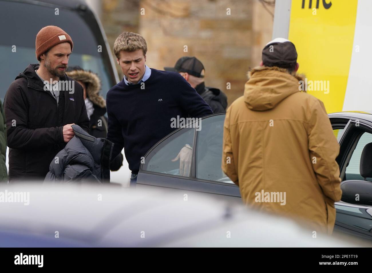 Ed McVey gets into a car as he plays the part of Prince William as they ...