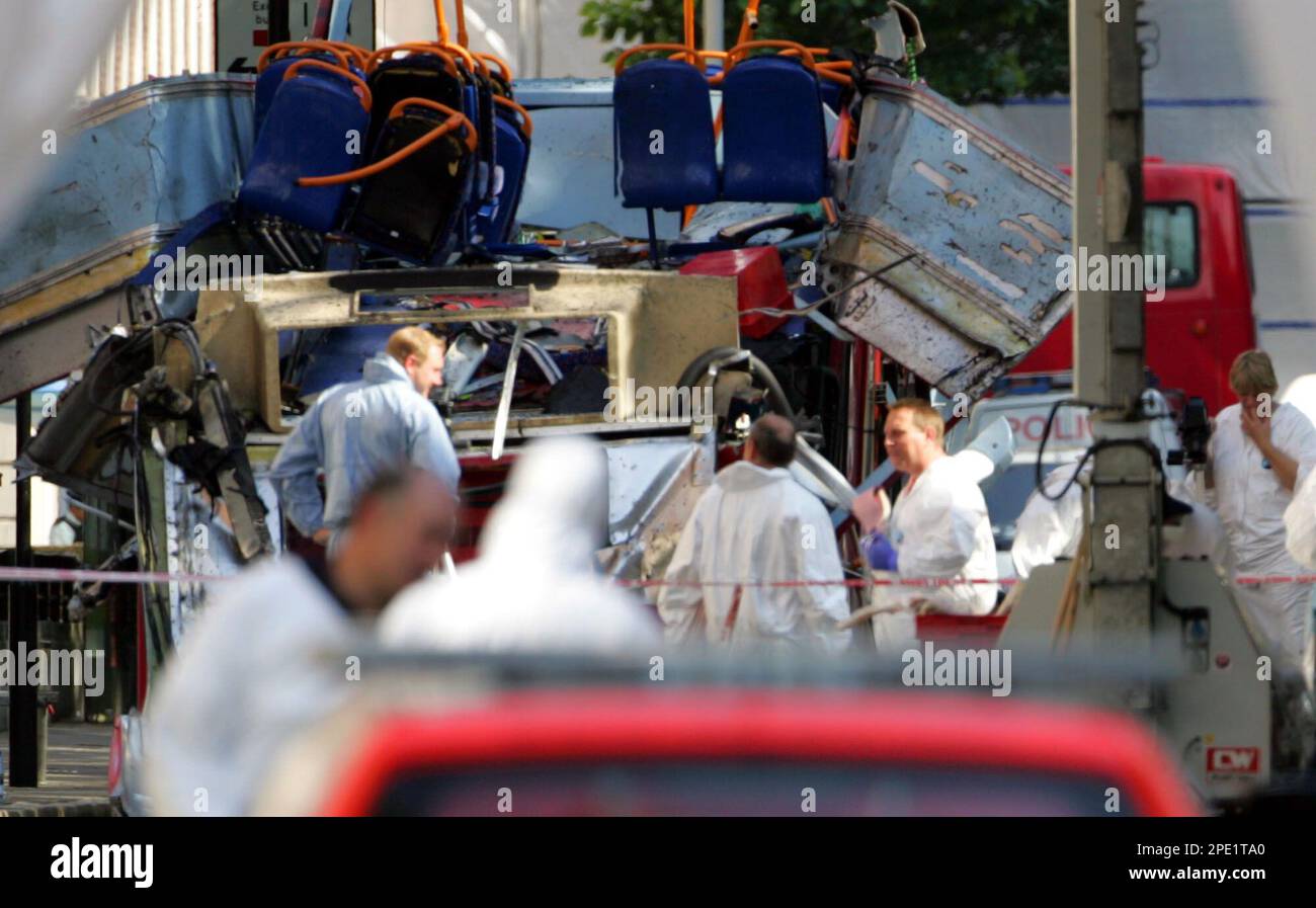 Forensic experts gather near the remains of the number 30 bus in ...
