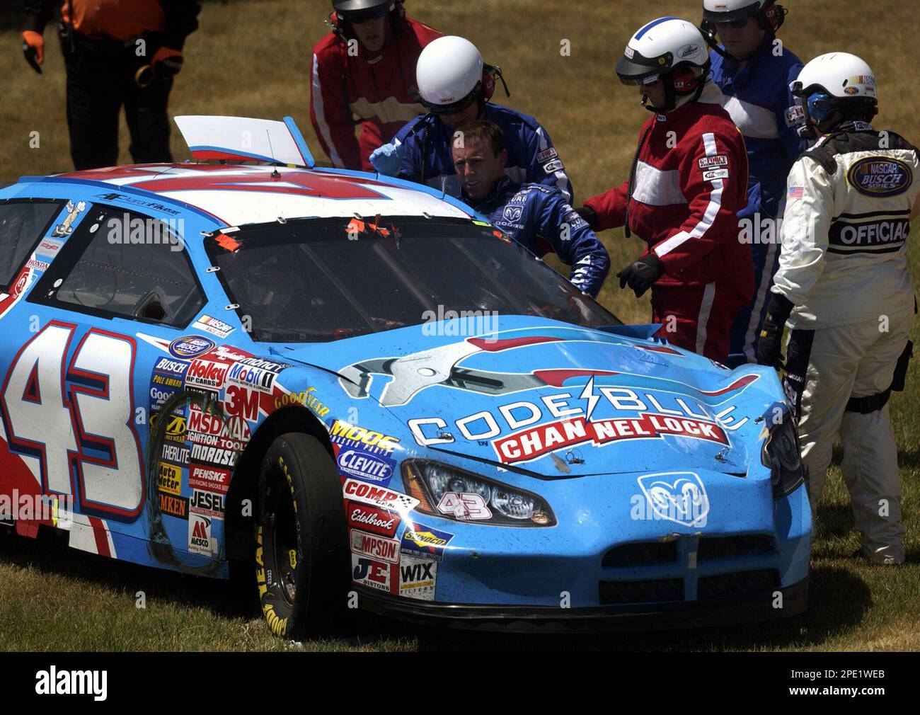 Driver Aaron Fike is helped from his car after hitting the wall during ...
