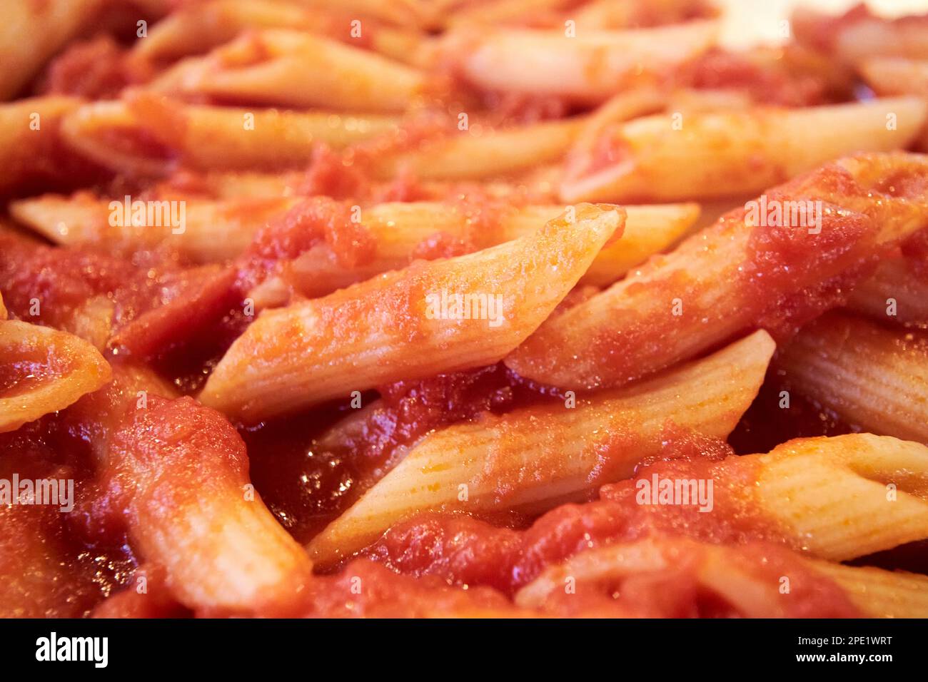 penne pasta in a simple tomato sauce close up Stock Photo - Alamy