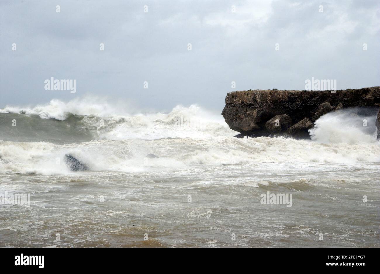 In this handout photo from the U.S. Navy, waves crash against a 30 ft ...