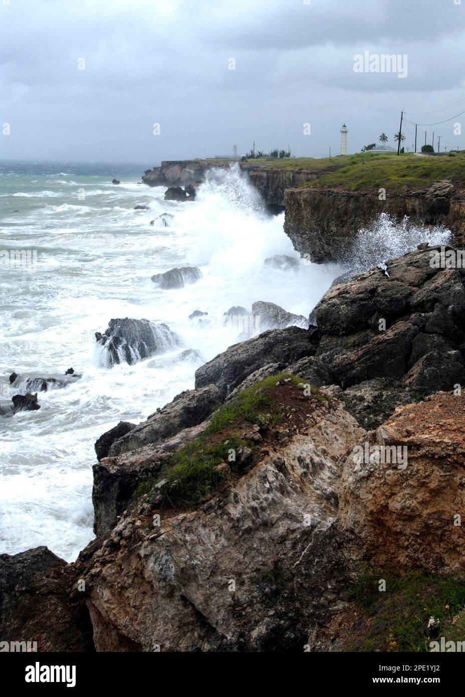 In this handout photo from the U.S. Navy, waves crash against a 30 ft ...