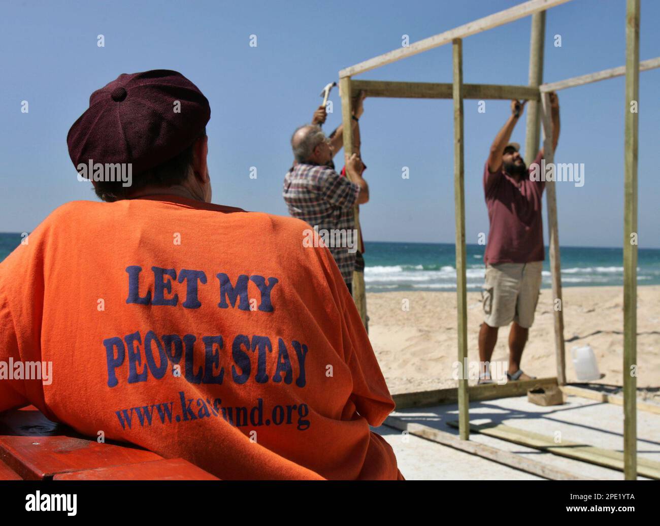 Settlers build a hut for visiting supporters due to arrive next week on ...