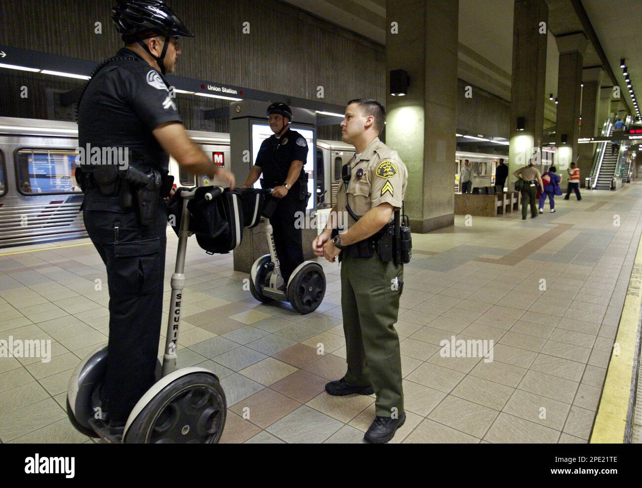 Metro Transit Security officer Louie Medrano, left, speaks with Los ...