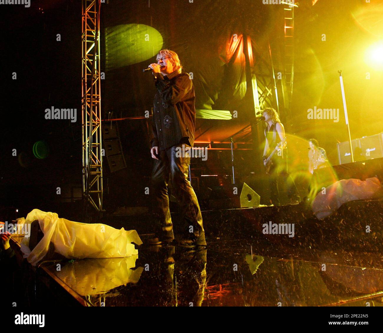 British rock band Def Leppard performs before a rain-soaked crowd of ...
