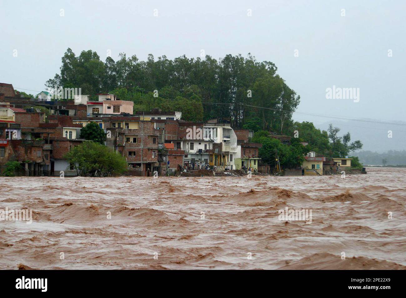 Water overflows the banks of the Tawi River in Jammu, India, Thursday ...