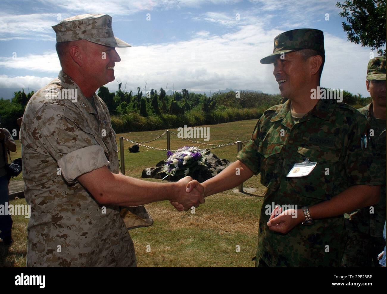 Col. Michael O'Neal, left, shakes hand with Maj. Gen. Taiichi Sekiguchi ...