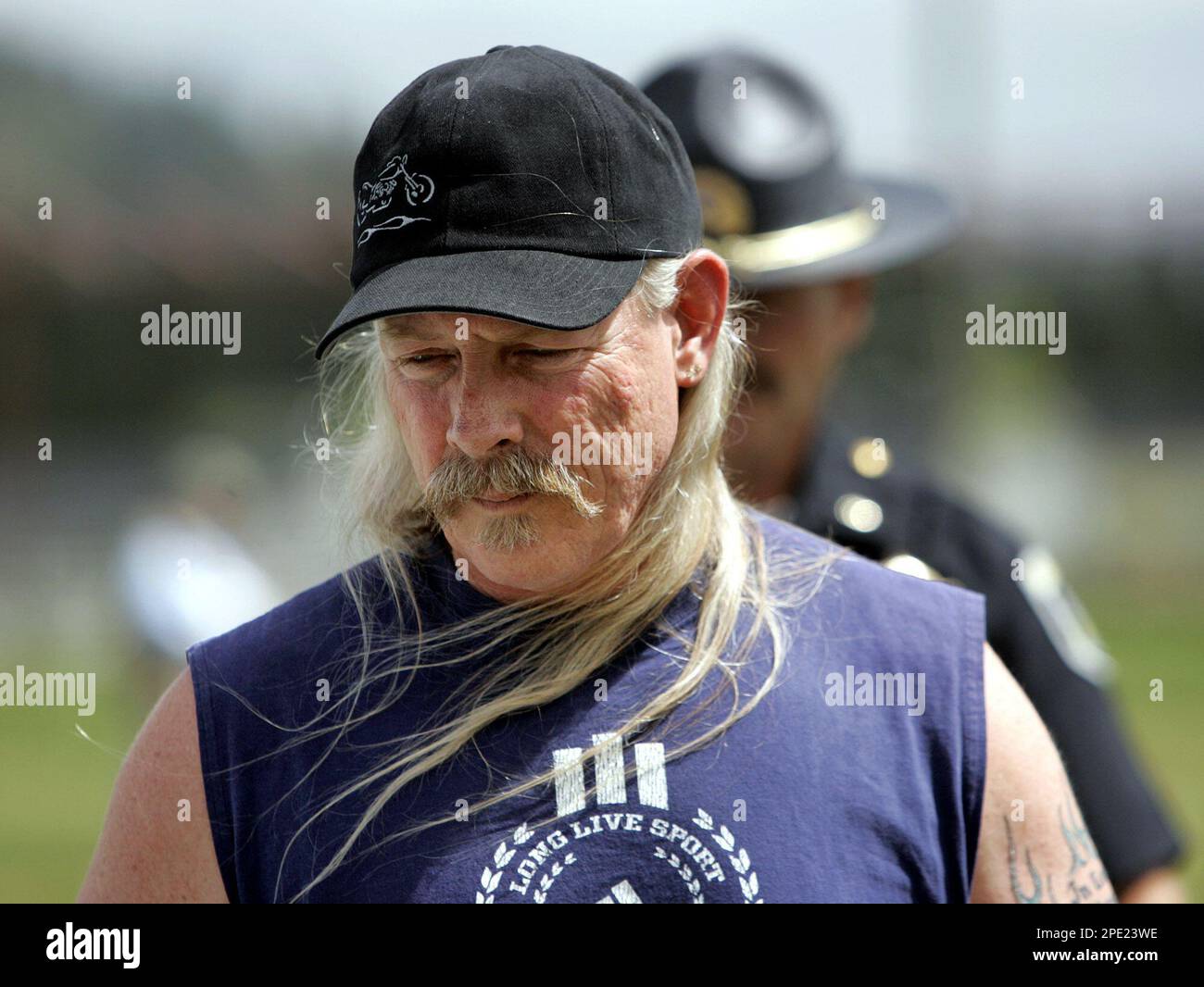 Steve Groene is escorted by an Idaho State Patrol trooper after reading ...