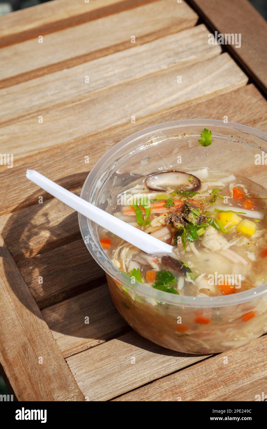 Chicken and mushroom soup in a cheap clear plastic container with a ...