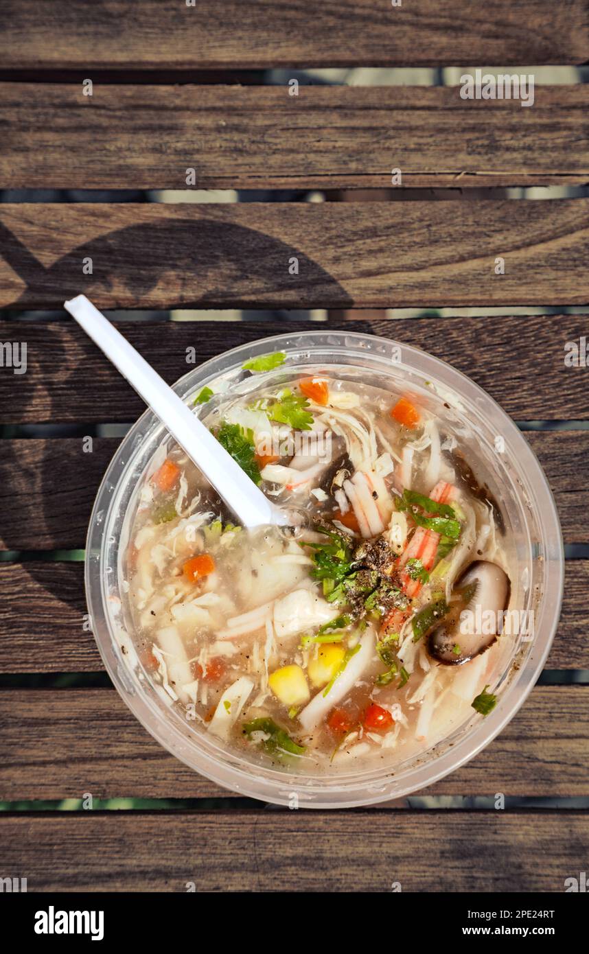 Chicken and mushroom soup in a cheap clear plastic container with a ...