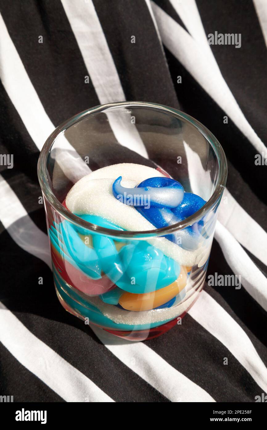 Various toothpaste of many colors squeezed into a glass. Delicious ...