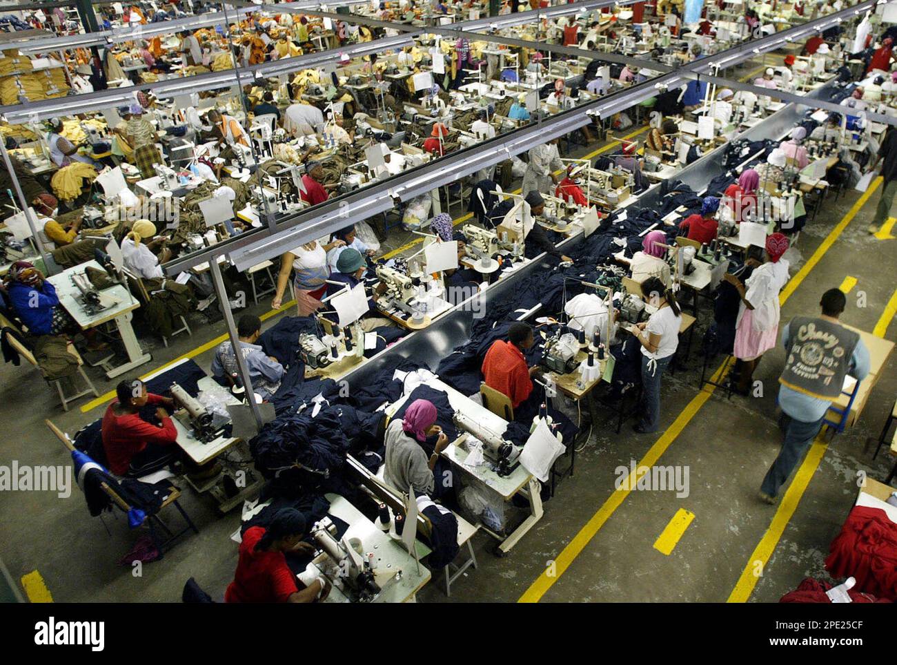** FILE ** Workers at their sewing machines in the Shining Century ...