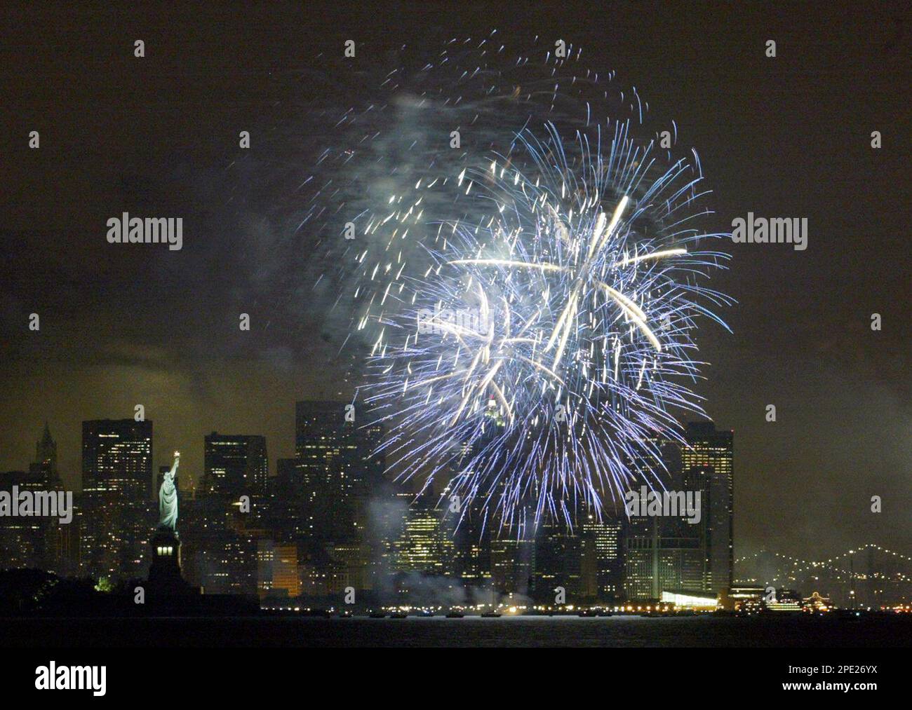 The Statue of Liberty can be seen at left during the Macy's Fourth of ...