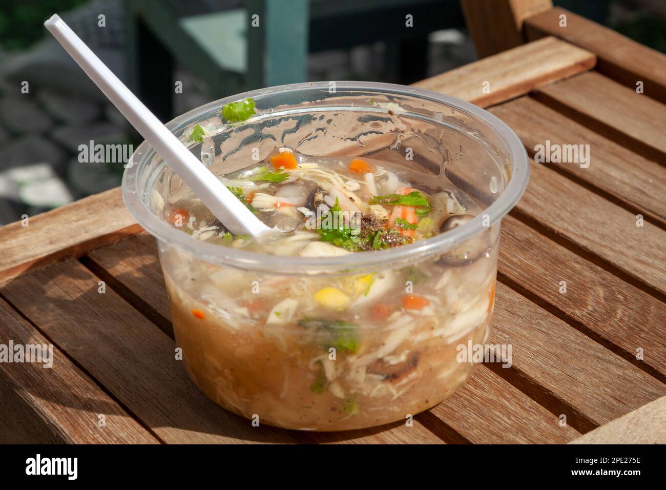 Chicken and mushroom soup in a cheap clear plastic container with a ...