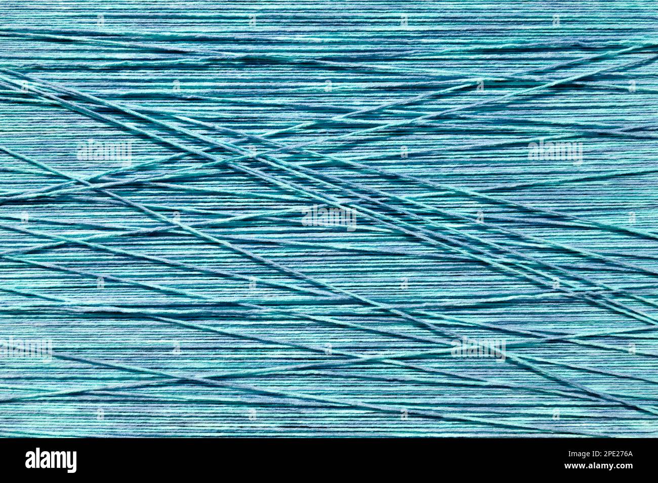 Sky blue yarn threads stretched on a loom abstract background. Turquois ...