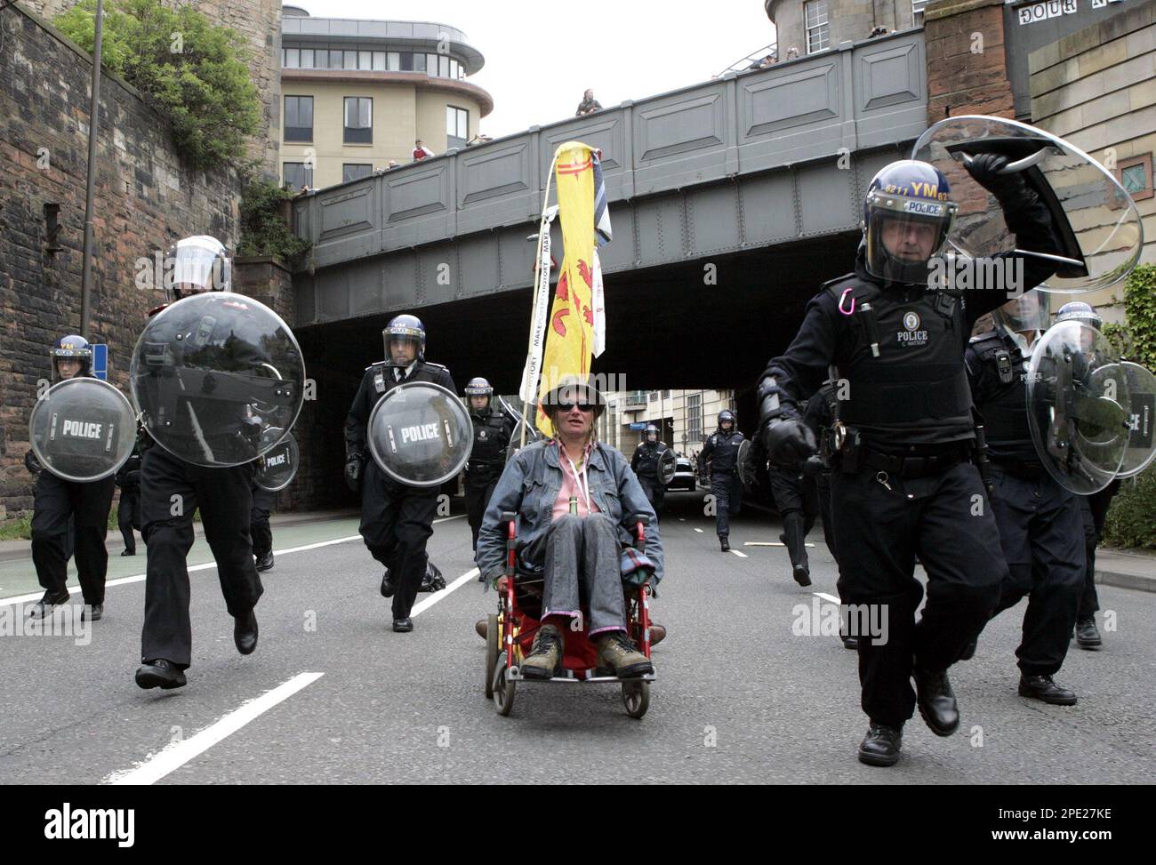 Police run by a protestor during anti-G8 demonstration in Edinburgh ...