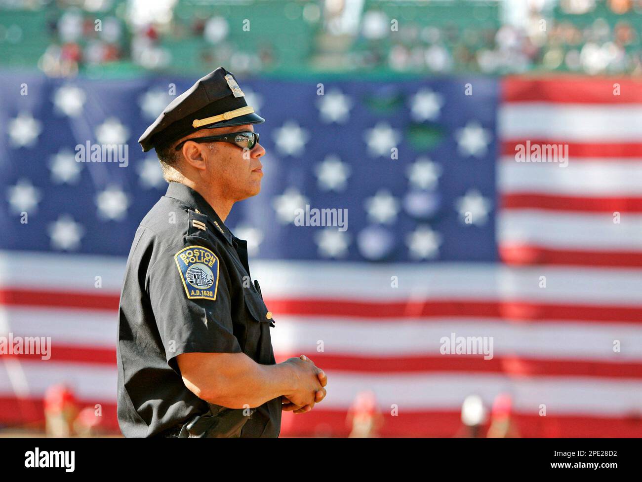 Boston Police captain Pervis Ryans stands guard in front of a huge ...