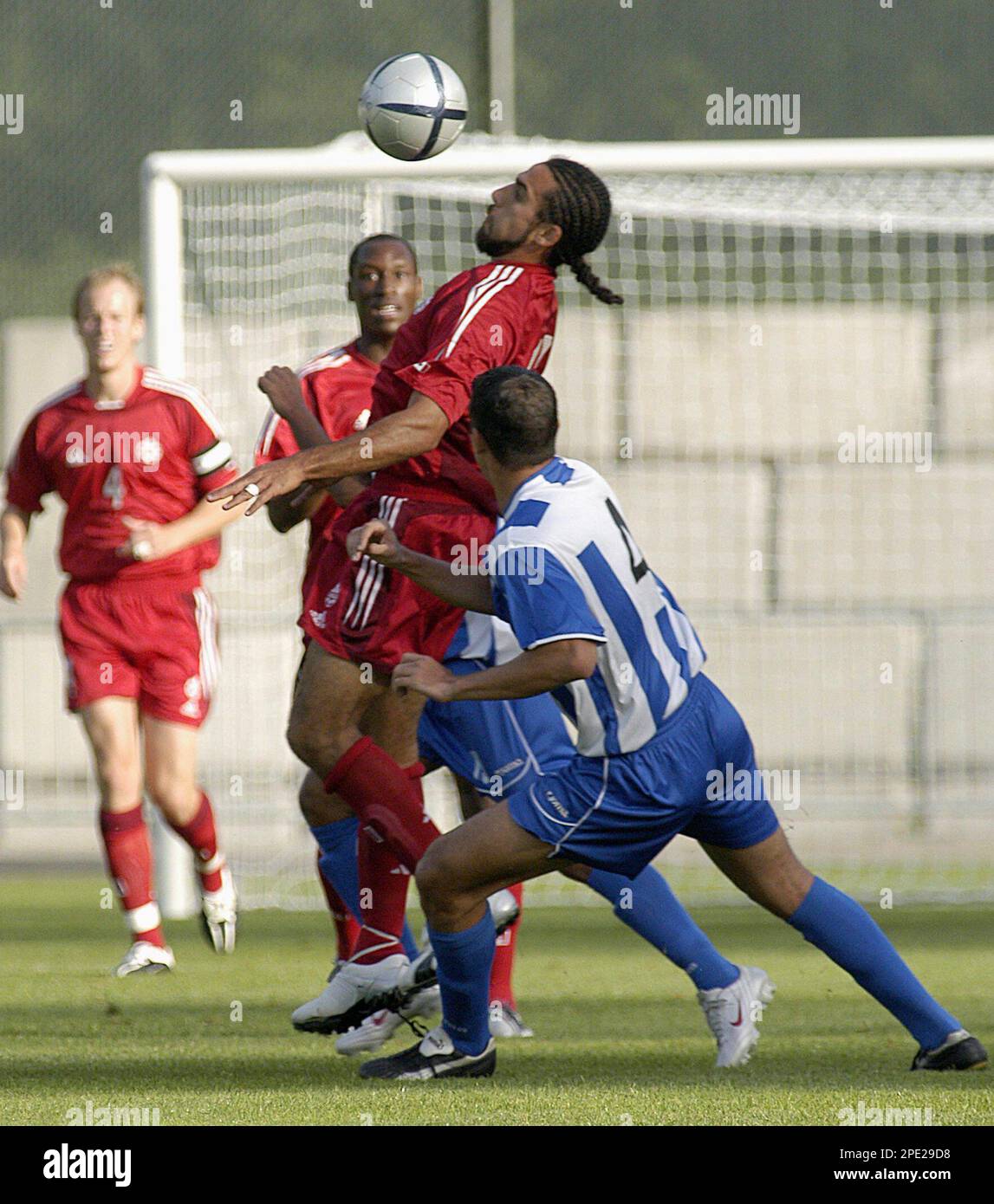 Team Canada's Dwayne Derosario tries to control the ball while team ...