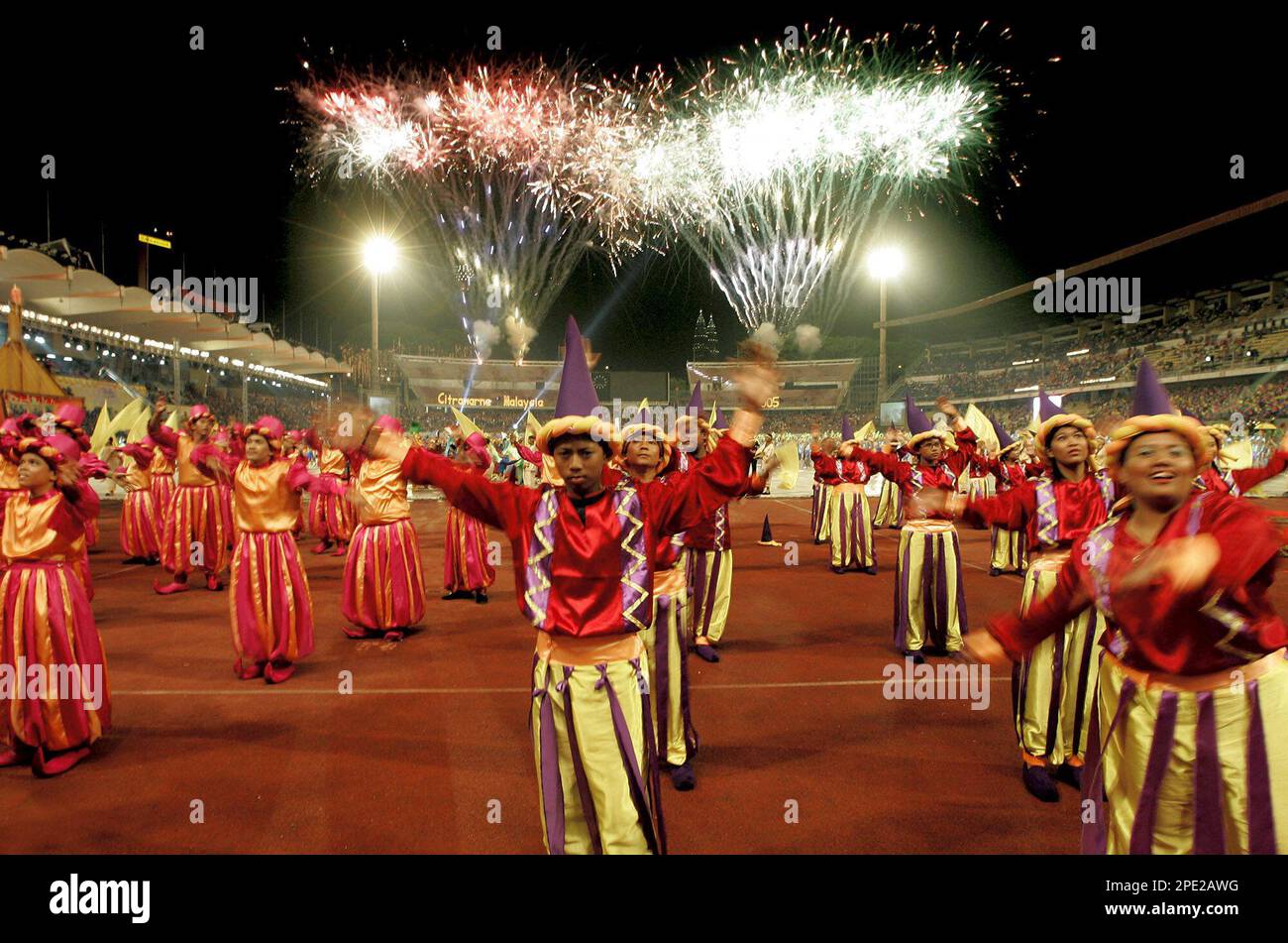 With fireworks lighting up the stadium, Malaysian dancers perform the ...