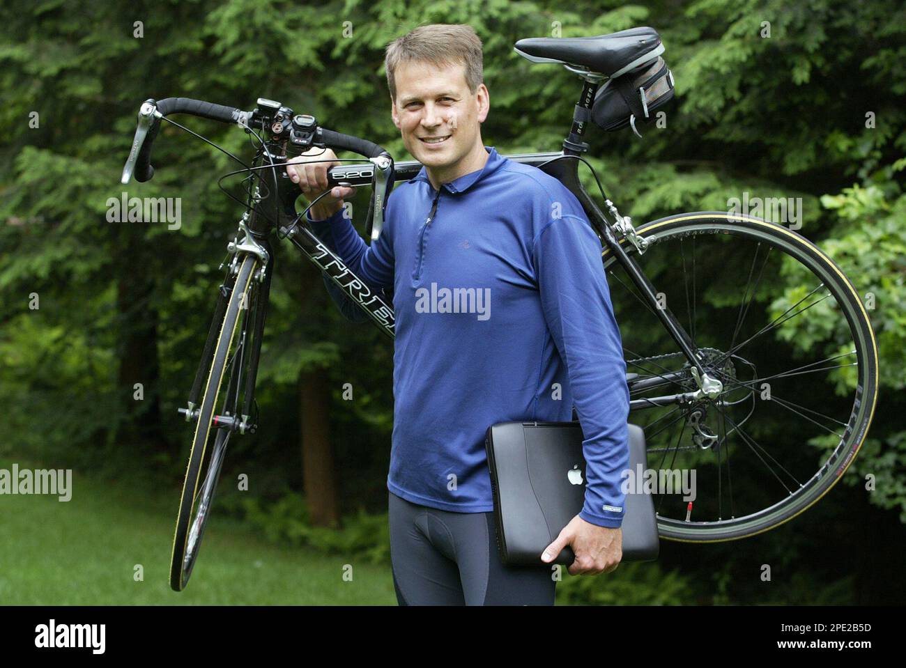 Ted Darling, 42, poses with his bike and laptop computer Thursday, June ...