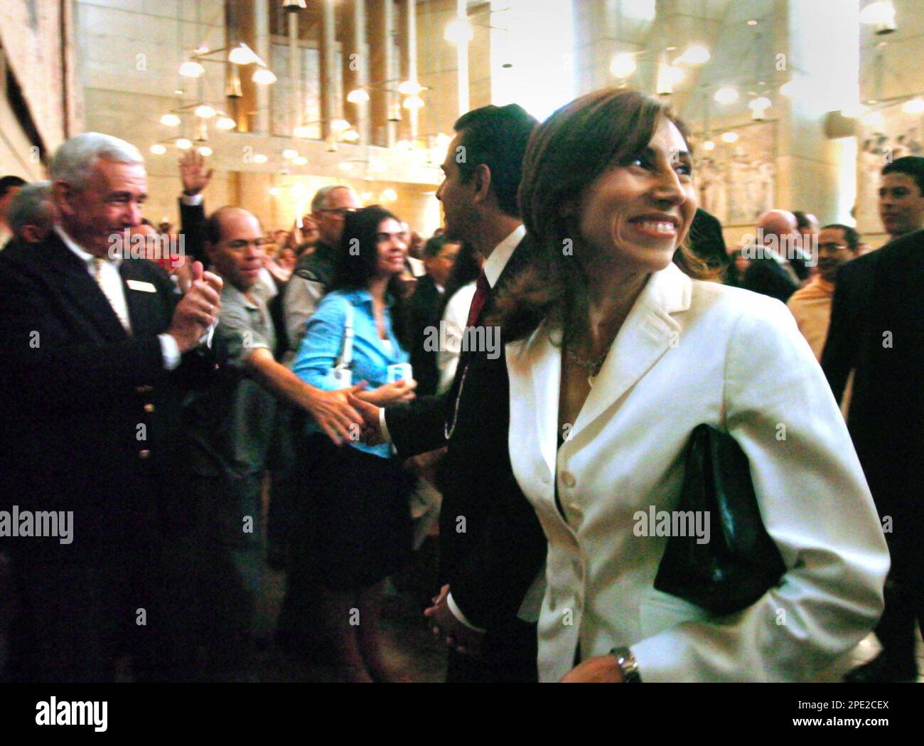 Corina Villaraigosa smiles to the crowd while walking out of the ...