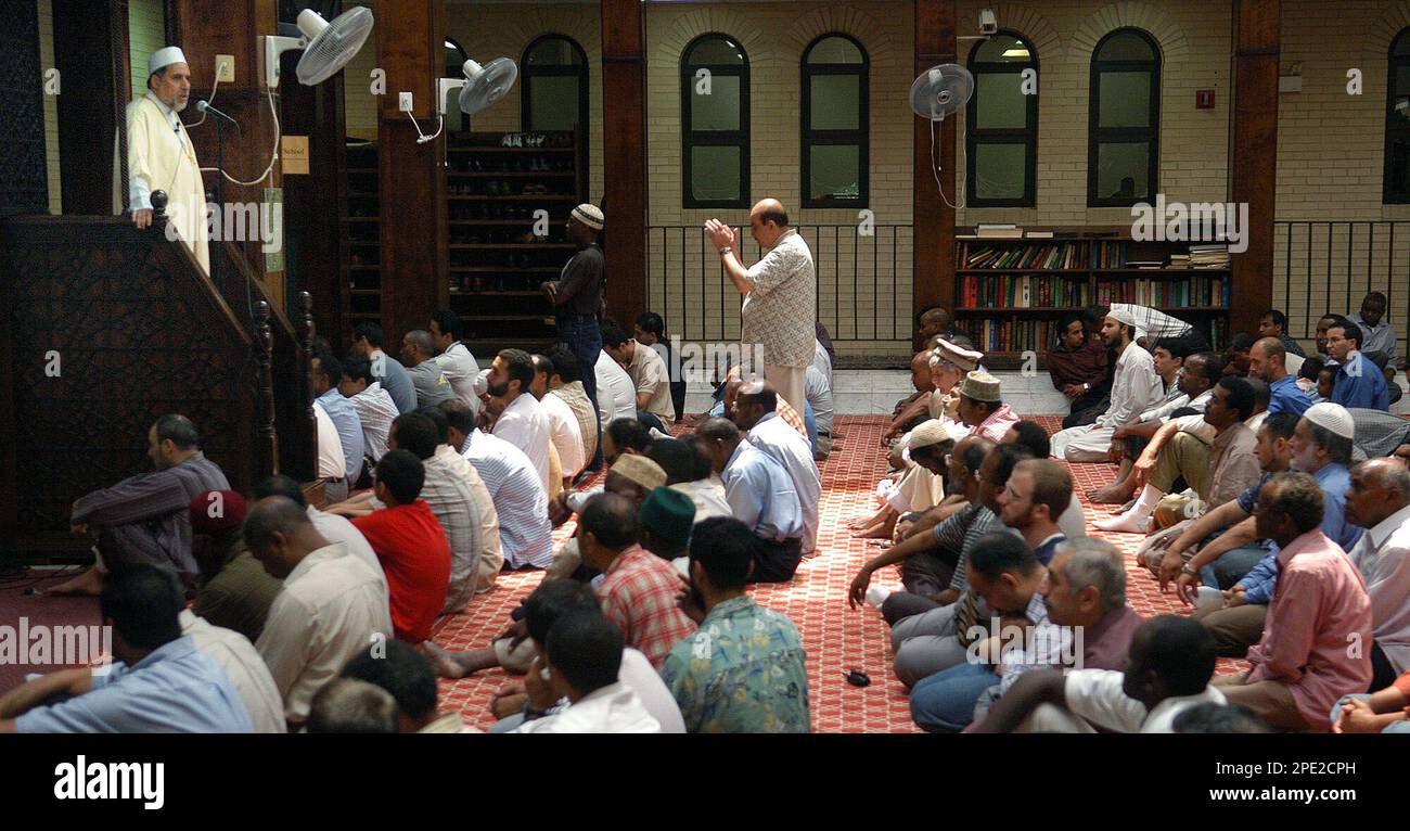 Imam Shaker Elsayed, left, delivers his sermon during prayer services ...
