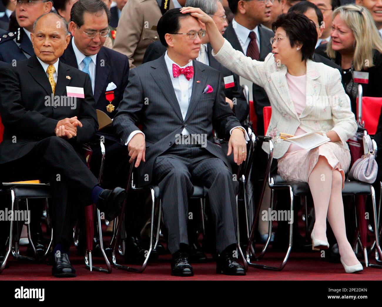 Hong Kong's new leader Donald Tsang center, is adjust hair by his wife ...