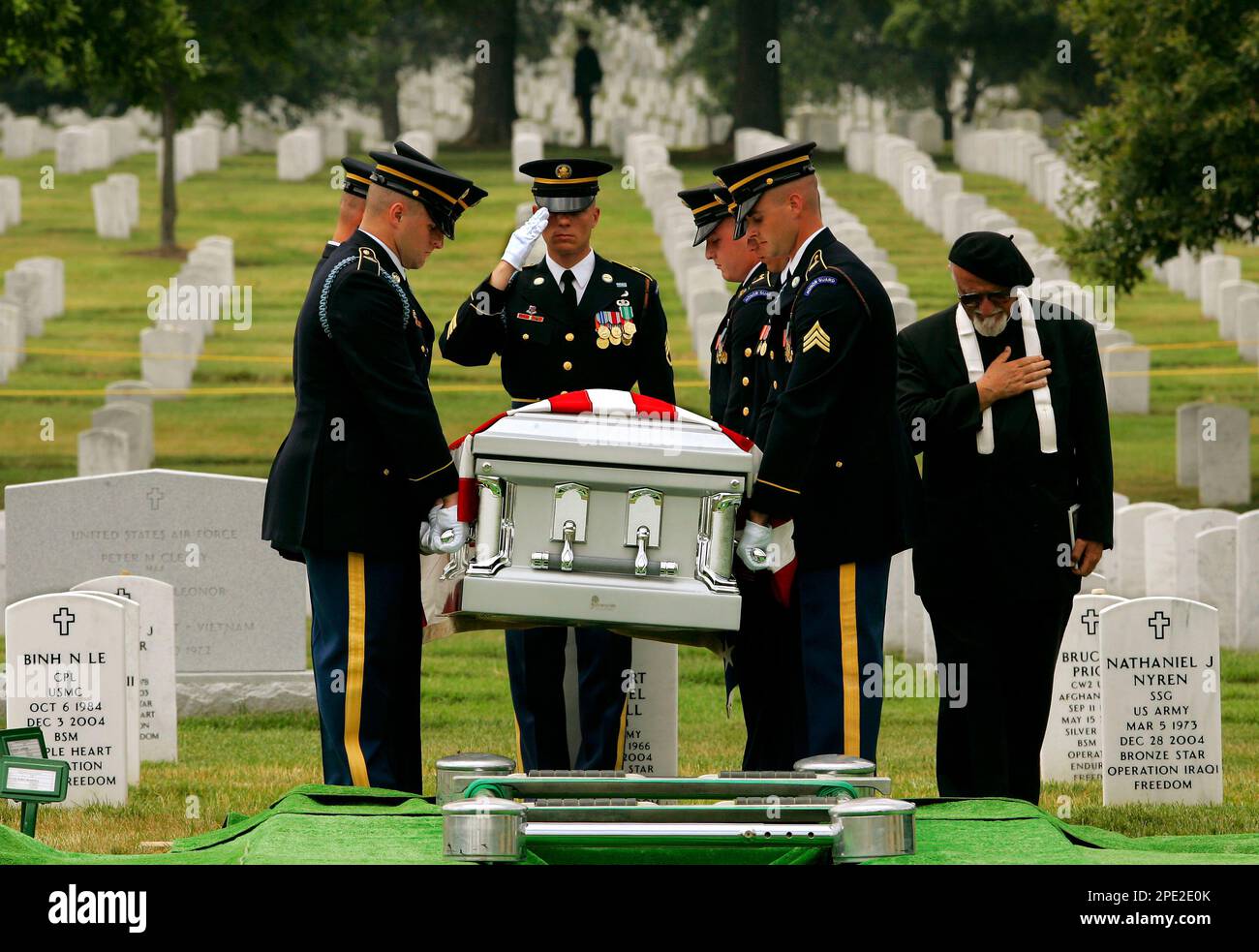 An Army casket team carries the flag-draped remains of Cpl. Stanley ...