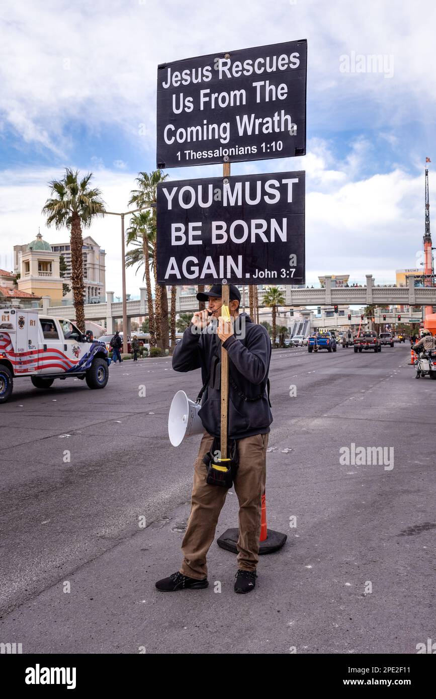 Street preacher on the Las Vegas Strip carry’s a megaphone and a sign ...