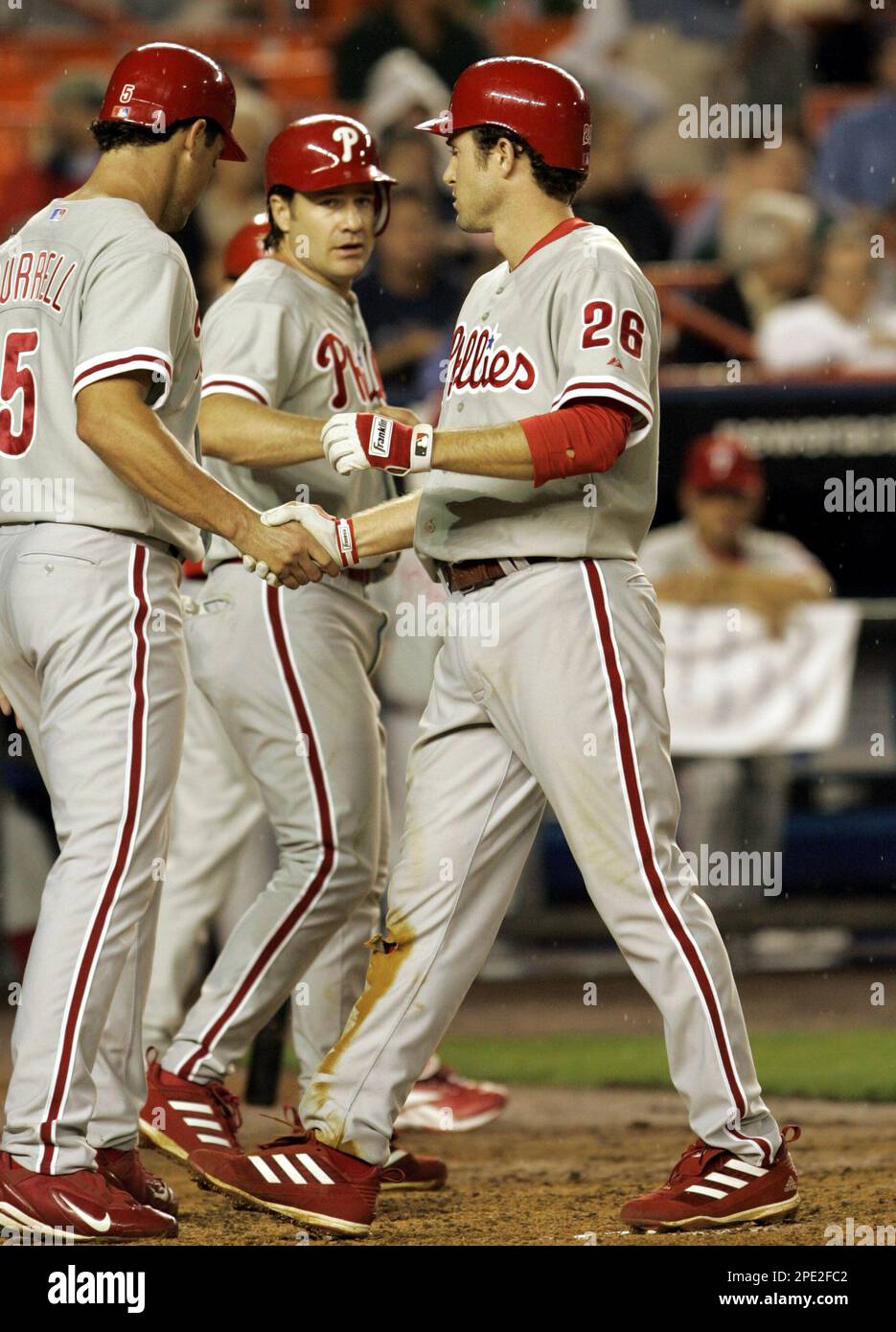 Philadelphia Phillies Chase Utley is greeted at the plate by teammates ...