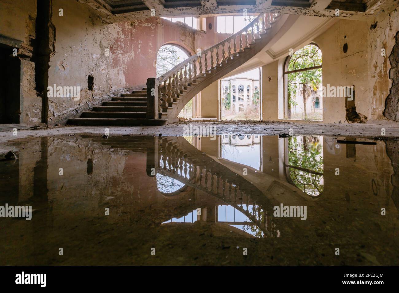 Old flooded abandoned mansion with spiral stair, water reflection Stock ...