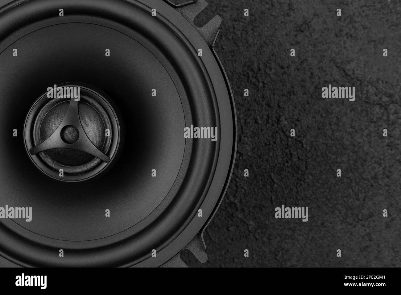 Stylish car audio acoustic round speaker on dark black background, top ...