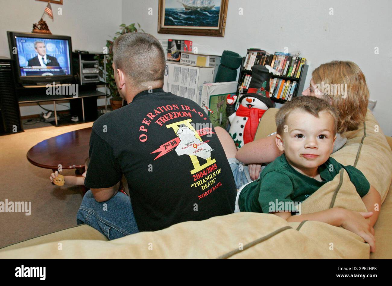 U.S. Marine SSGT Shawn Doty, left, watches President Bush's speech ...