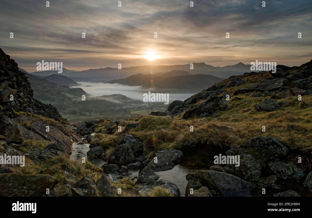 Snowdonia dramatic sunrise with mist in valley below Stock Photo - Alamy