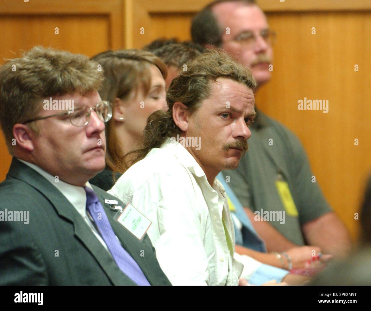 Steve Relford leans forward to look at Dennis Rader (not shown) as ...