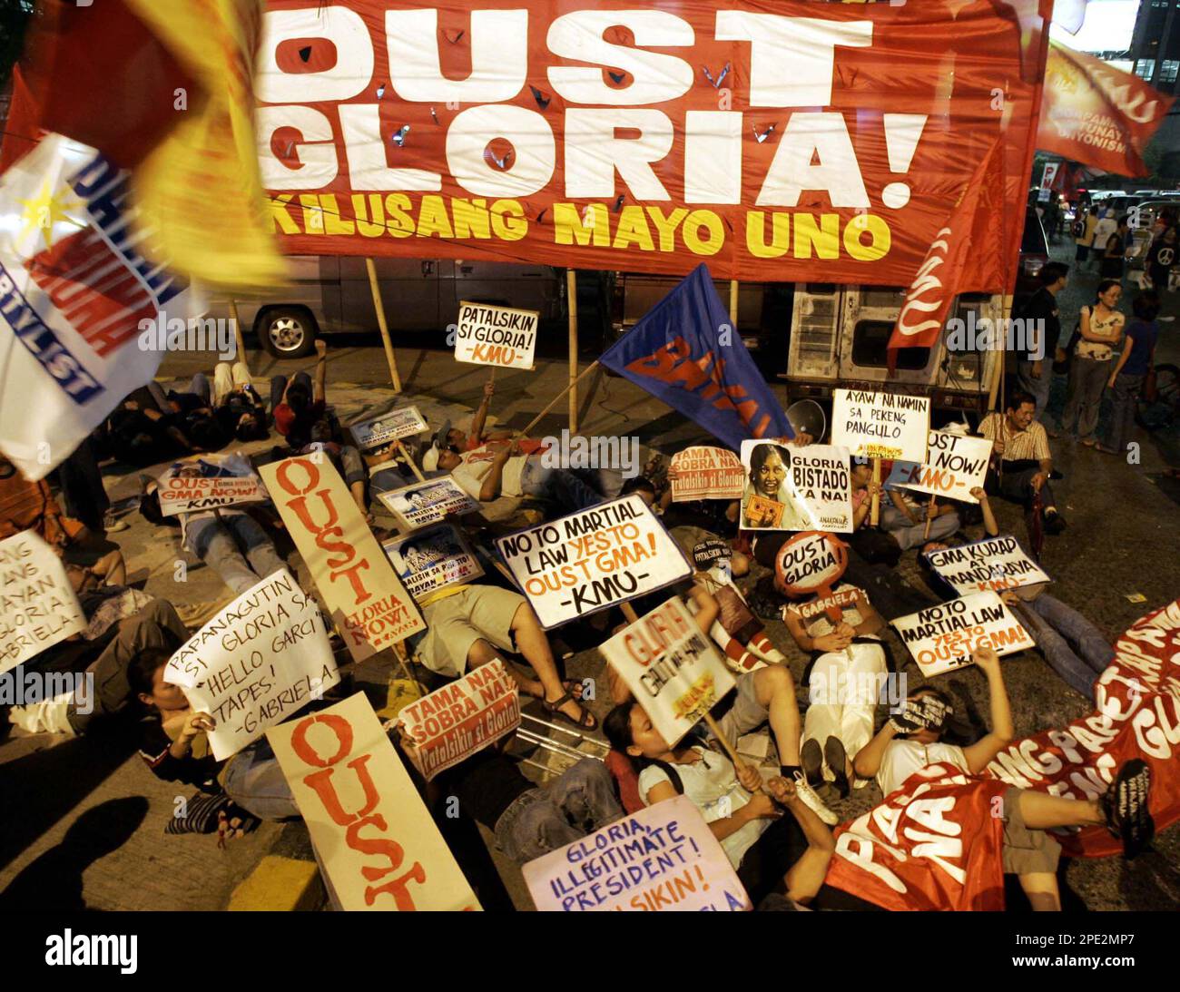 Filipino protesters stage a die-in rally as they call for the ouster of ...