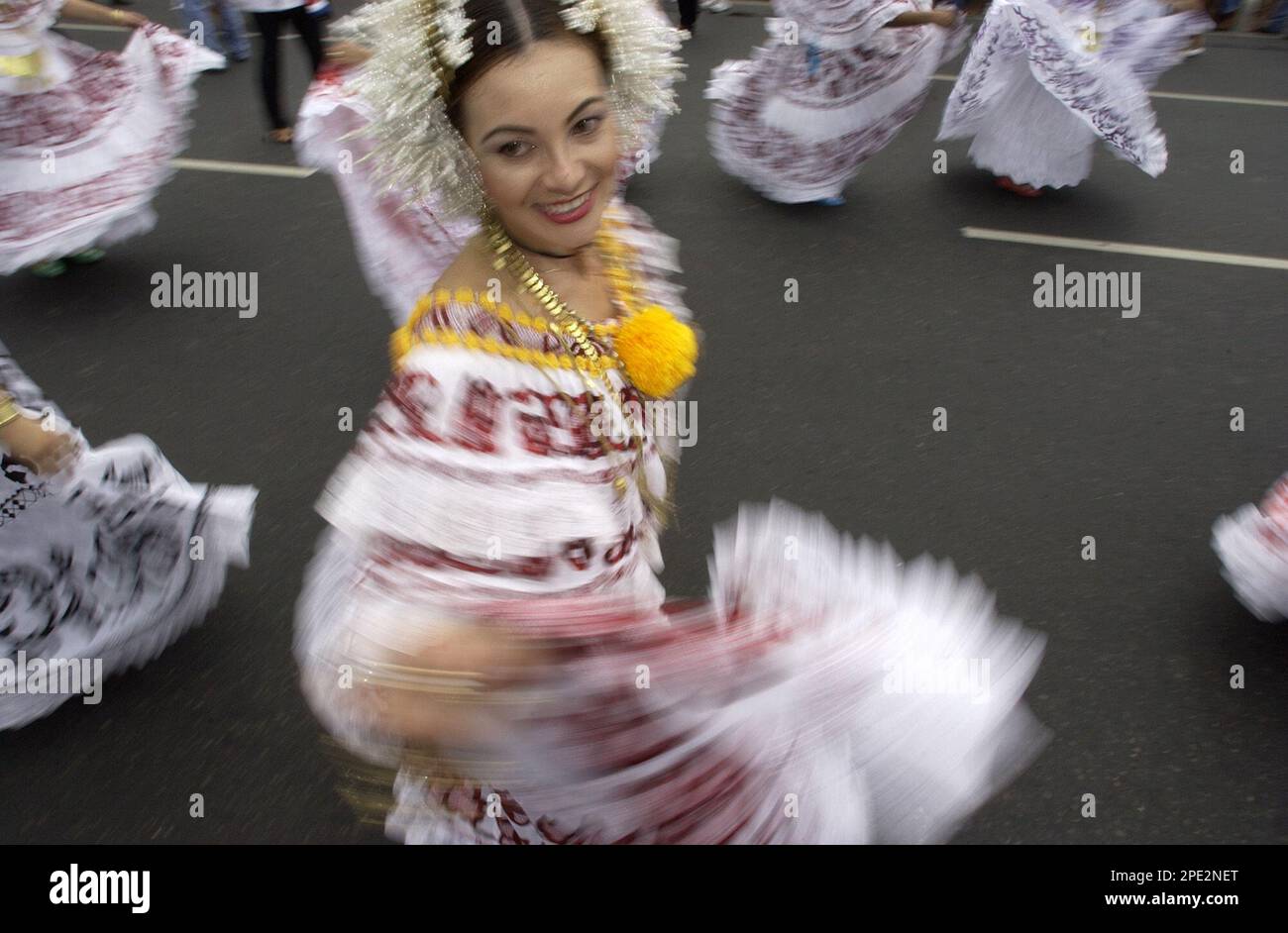 A woman dances through the streets wearing a Panamanian traditional ...