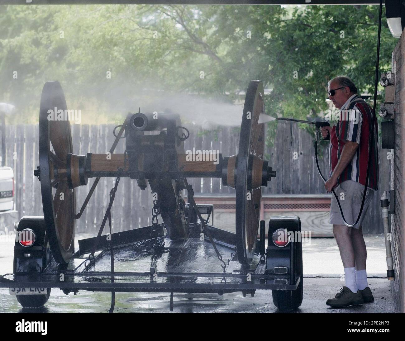Tom Lupton uses a pressure hose at a car wash to clean his replica of a ...