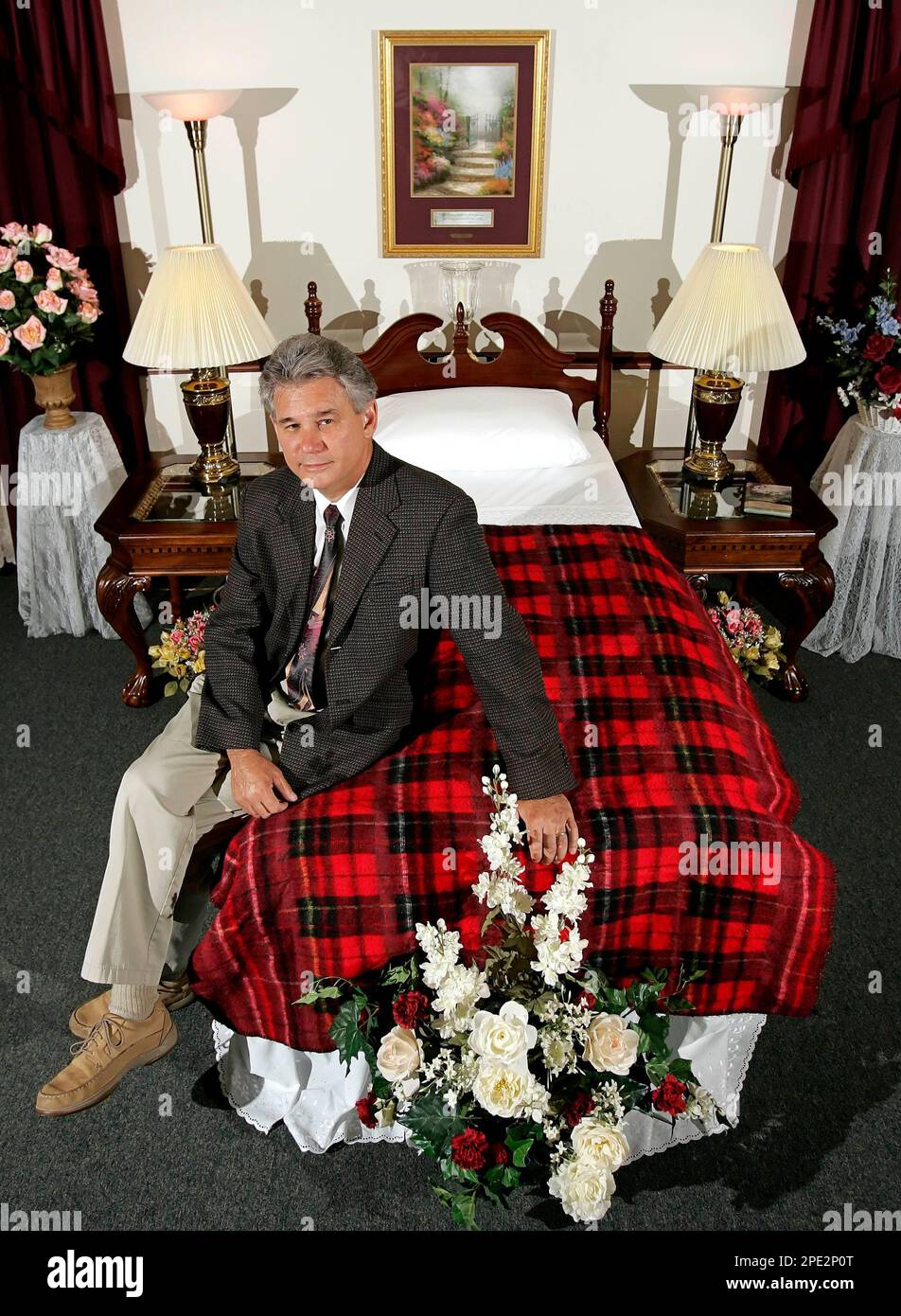 Joe Humenik sits on a funeral bed at his Humenik Funeral Chapel in ...
