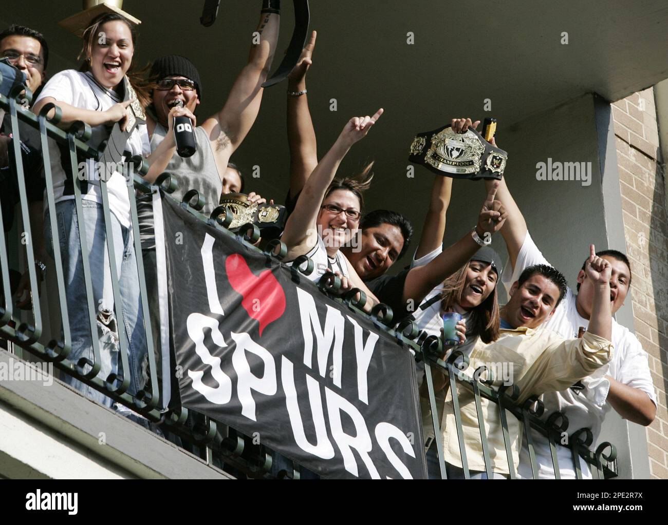 San Antonio Spurs fans cheer from a balcony as players pass during a ...