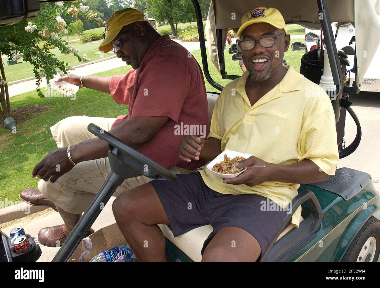 Mark Duper, right, enjoys a bowl of jambalaya while he and former Miami ...