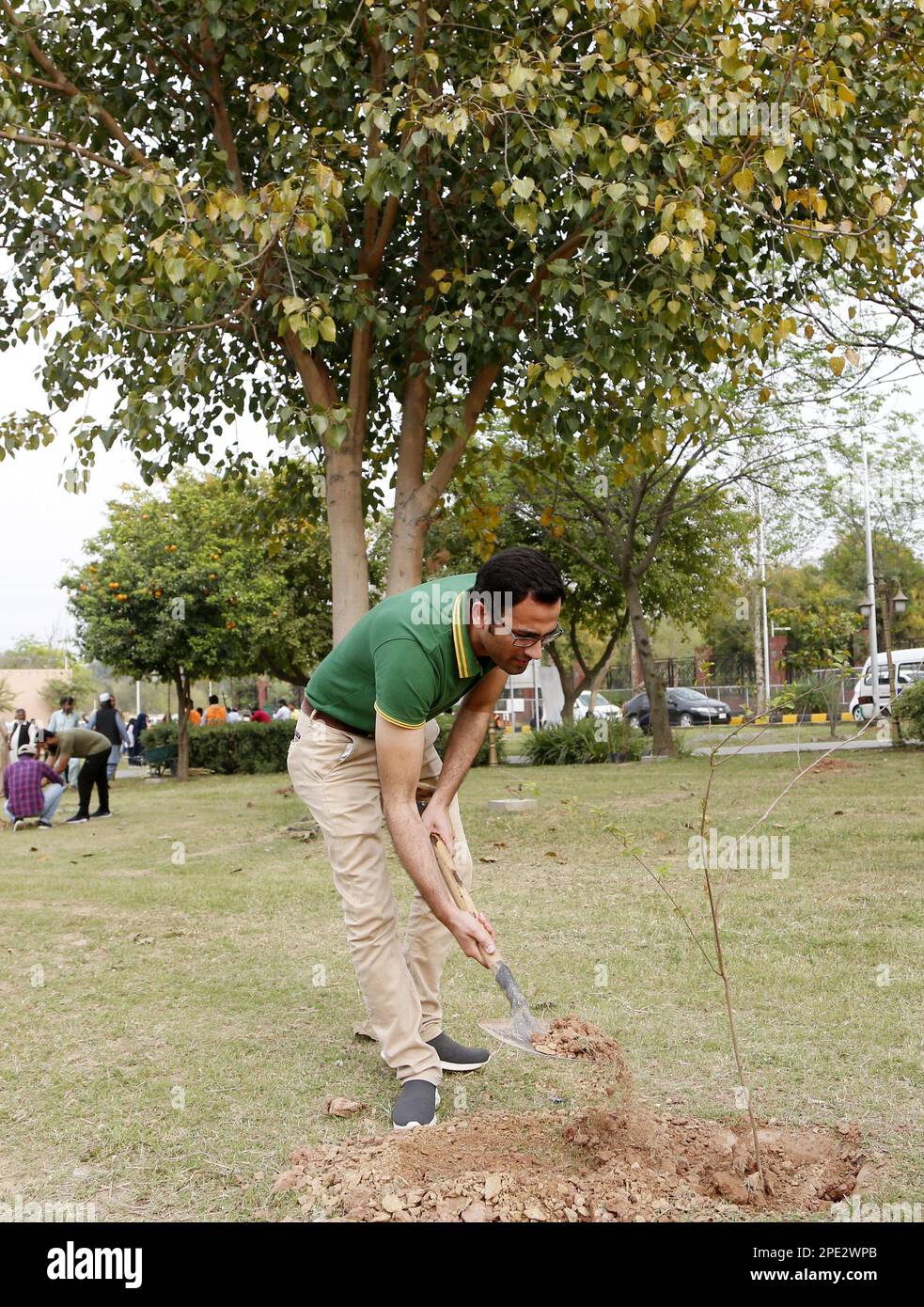 Islamabad, Pakistan. 15th Mar, 2023. A man plants a tree during a ...