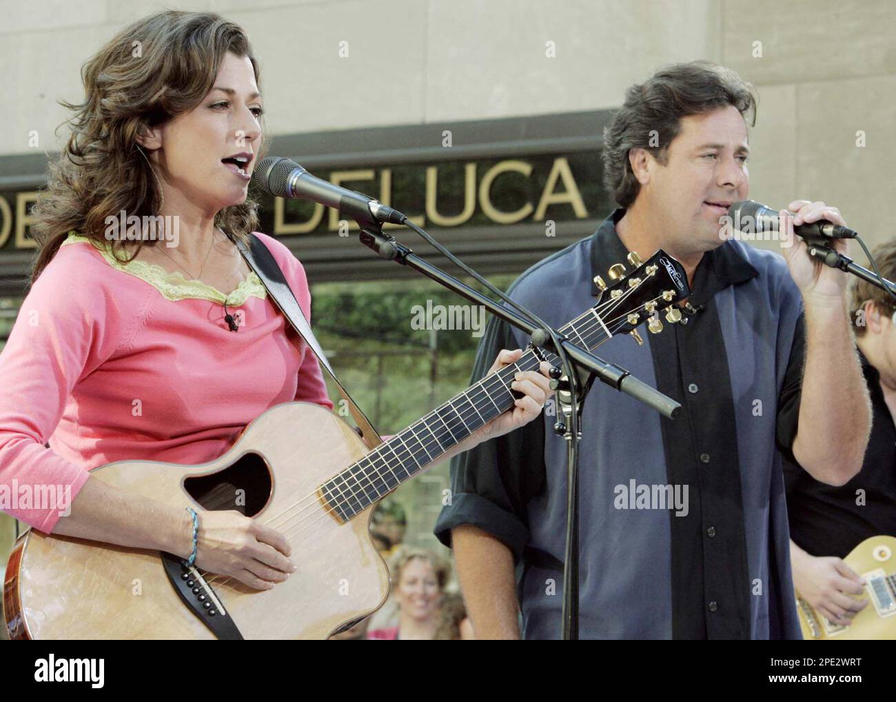 Country singer Vince Gill and his wife Amy Grant sing during their ...