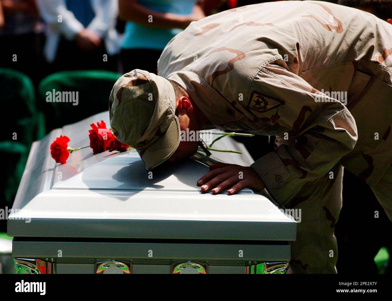 Spc. Patrick Brunson kisses the coffin of Spc. Anthony S. Cometa, of ...