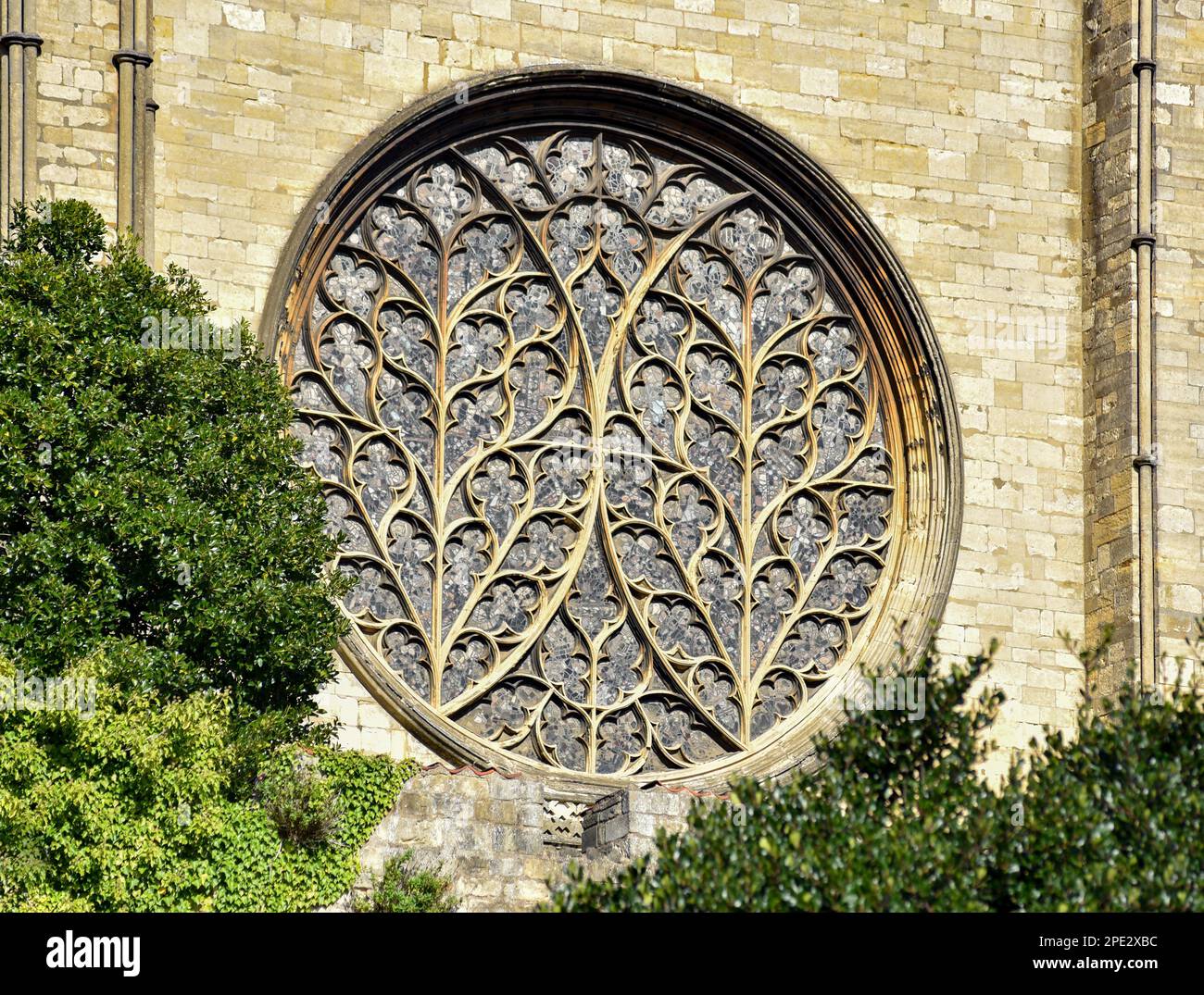 A stained round glass window featuring gothic-style details in a ...