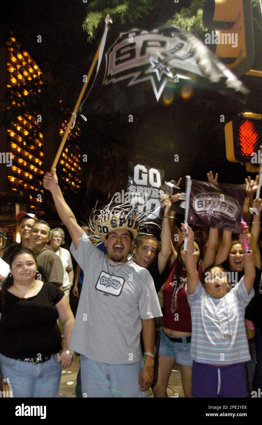 Spurs fans celebrate in the streets after their team beat the Detroit ...